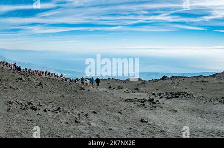 Sicily, Italy - September 26, 2022: people climbing the volcano Etna in ...