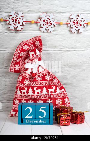 25 december. Christmas composition on colored background with a wooden ...