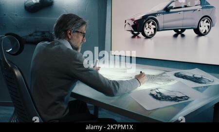 Automotive graphic designer draws sketch of the prototype model of a ...