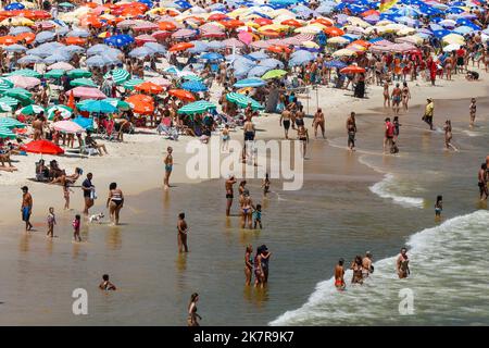 Vendor of Matte Leão drink at Copacabana beach. Man walks with coolers ...