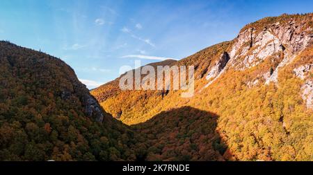 Aerial panorama of Smugglers Notch looking towards Stowe in fall colors ...