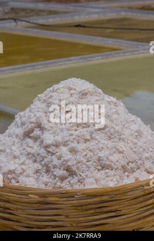 Salt is drying in baskets on the side of the saline pools at a salt ...