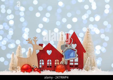 House figures with key and Christmas decor on green background Stock ...