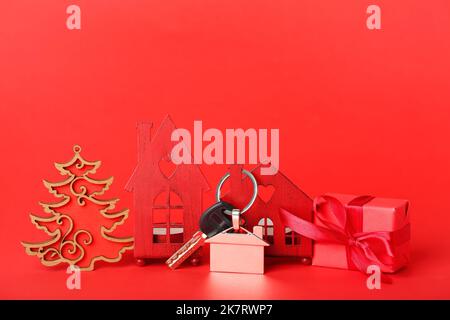 House figures with key and Christmas decor on green background Stock ...