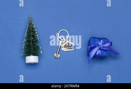 Key from new house and Christmas decor on red background Stock Photo ...