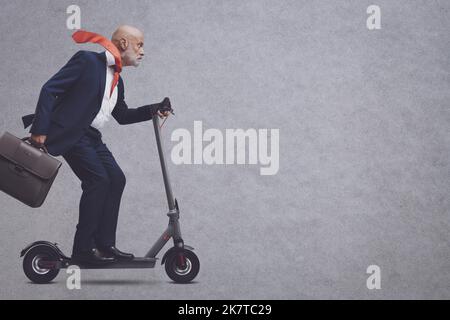 Travelling business executive riding a fast eco-friendly electric ...