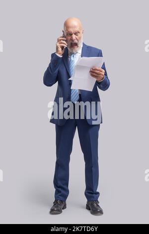 Angry customer holding expensive utility bills, he is calling the ...