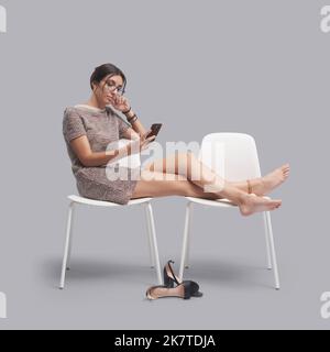 Rude woman sitting with feet up in the waiting room and connecting with ...