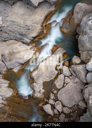 A long exposure shot of flowing creek with dark surrounding Stock Photo ...