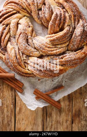 Kringle Delicious Brioche with sugar and cinnamon closeup on the paper ...