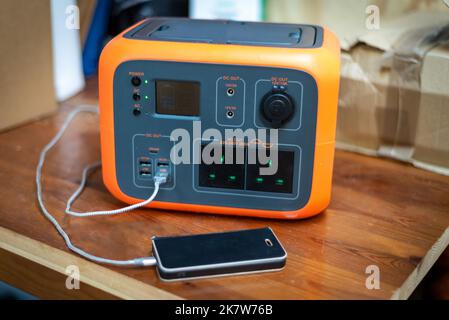 Portable power station solar electricity generator on table with mobile ...