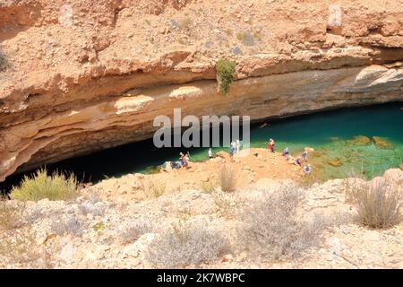 March 22 2022 - Bimmah sinkhole, Oman: People enjoy one of the world ...