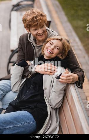 View of autumn park with bench and red trees Stock Photo - Alamy