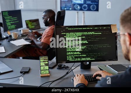 Background image of software development office with green code lines ...