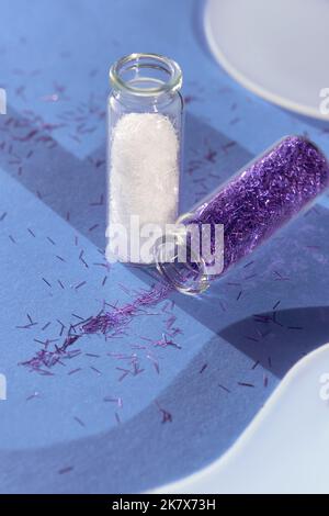 Neon colored powder glitter products on pink sparkling background ...