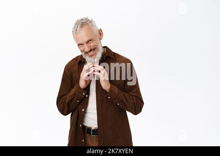 Greedy old man scheming. Senior guy with white hair and beard, steeple ...
