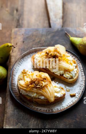 Sweet toast with pear, cheese and honey Stock Photo - Alamy