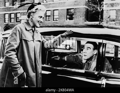 THE SOLID GOLD CADILLAC, director Richard Quine (right) with wife ...
