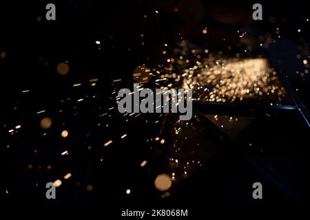 Metal grinding. Sparks from friction. Lights in dark. Chaotic flight of ...