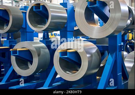 Large rolls of electrical transformer steel hang on rack Stock Photo ...