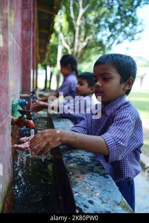Students of Vivekananda High School are washing their hands before ...