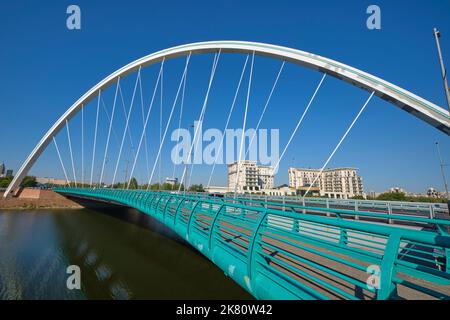 A view of the modern, curved, cable suspended bridge over the Ishim ...