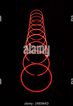 Whirling red light circles on black background Stock Photo - Alamy
