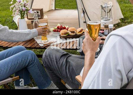 camping mood aesthetics drinking beer Stock Photo - Alamy