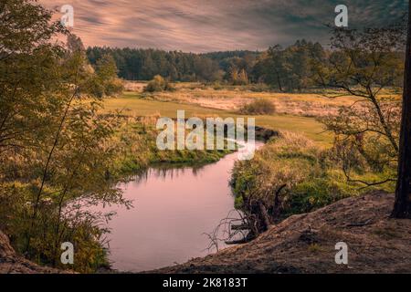 Beginning of autumn on the Grabia River lit by the setting sun, Poland ...