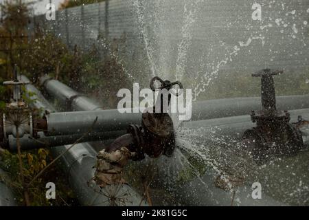 Pipe breaking with water. Pipeline accident. Hot water flows from pipes ...