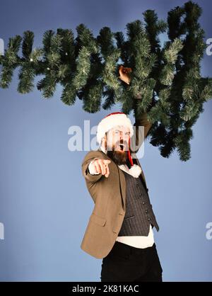 Businessman with raging face holds bald Christmas tree up Stock Photo ...
