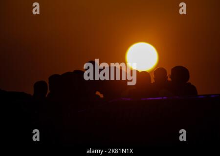 Palestinians sit in a cafe on the seaside during sunset. (Photo by ...