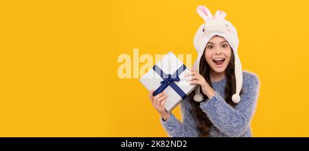 shocked teen girl wear earflap hat with purchase ox on yellow ...