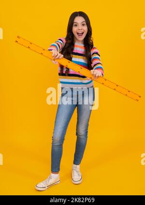 amazed kid in school uniform hold mathematics protractor for measuring ...
