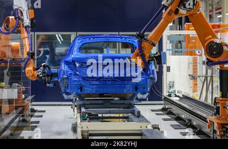 Robots paint a car body in the paint shop at Chrysler's Sterling ...