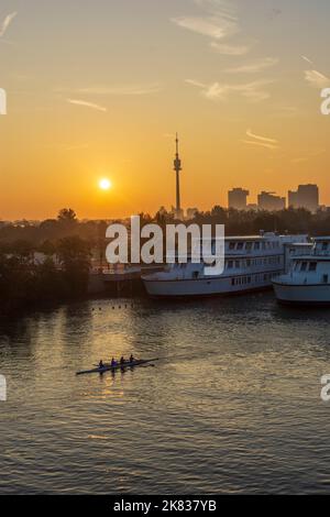 Wien, Vienna: rowing boat at sunrise at river Donau (Danube), school ...