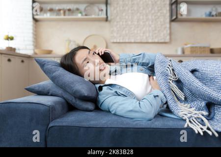 Asian young woman she sick blowing nose sneezing in tissue at home ...