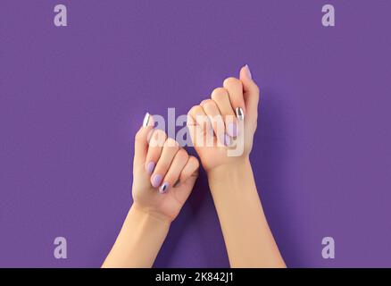 Beautiful groomed womans hands with matte lavender nail design on furry ...