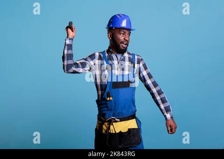 African american builder with coverall and protective helmet on ...