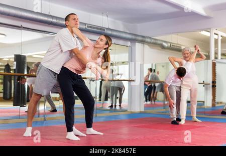 Young woman exercising elbow strike during self-protection training ...