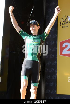 Pierre Rolland walks on the podium to collect his trophy on the podium ...