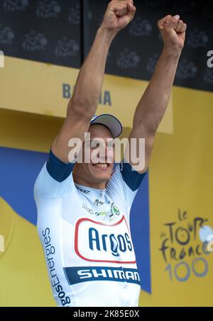 The overall leader's yellow jersey with rider's autographs is displayed ...