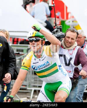 Australian Simon Gerrans of Orica GreenEDGE celebrates with arms up as ...