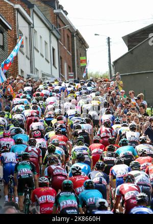 The Peloton climb through the lined streets in Houffalize on the climb ...