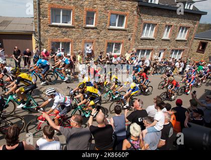 The Peloton climb through the lined streets in Houffalize on the climb ...