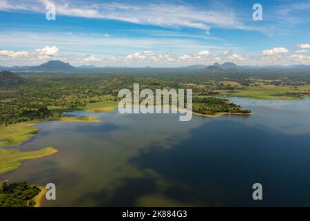 Sorabora lake in sri lanka with wooded hills and lakeside scenery under ...
