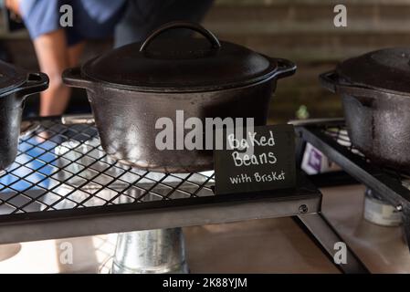 Buffet line has a cast iron pot of green beans for the guests to serve ...