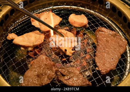 Korean BBQ restaurant, grilling Chicken and Beef Stock Photo - Alamy