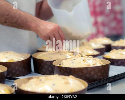chef topping panettone italian cake with almonds Stock Photo - Alamy