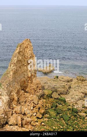 rock collapsed due to erosion due to wave motion by the sea Stock Photo ...